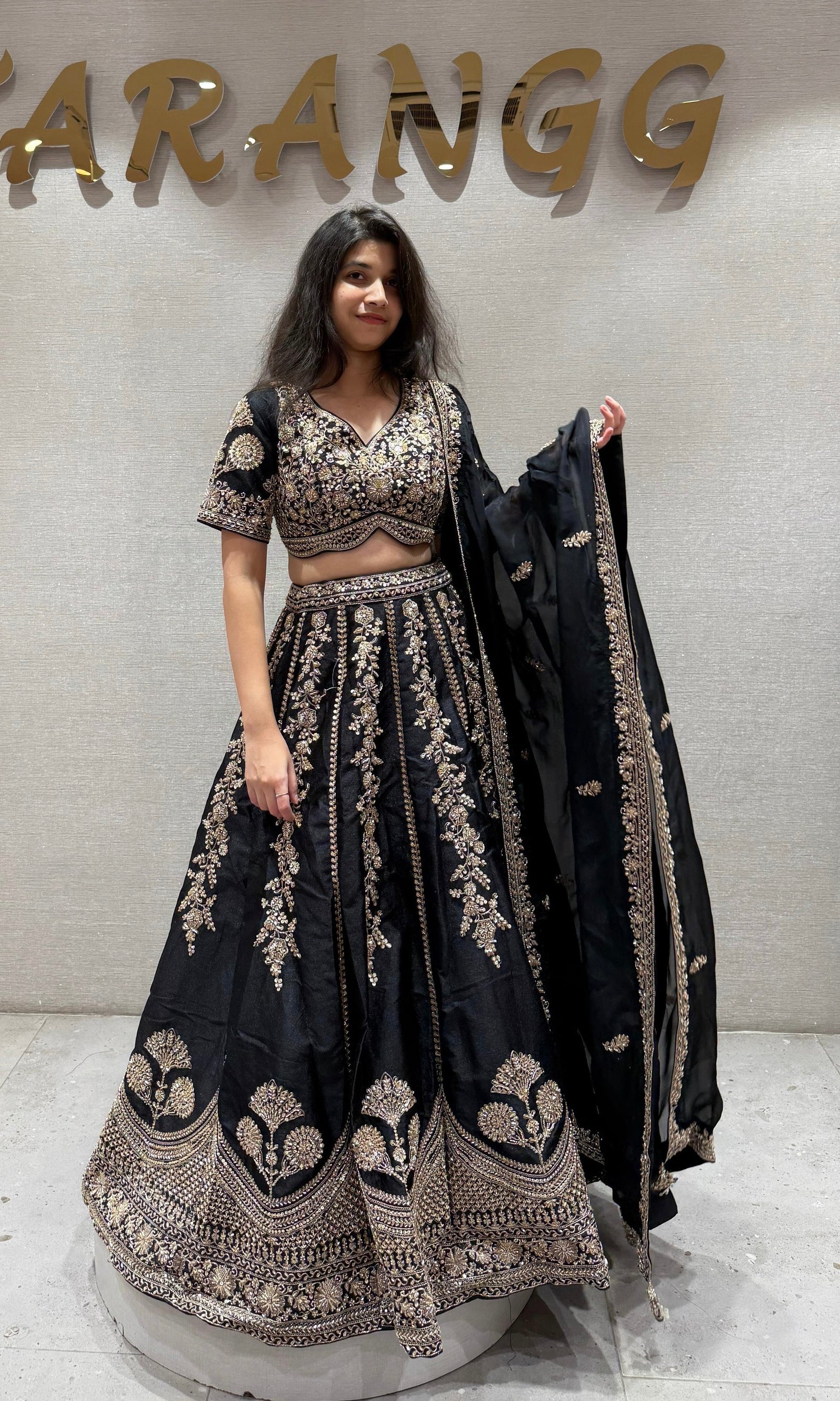 Black raw silk lehenga with intricate gold detailing